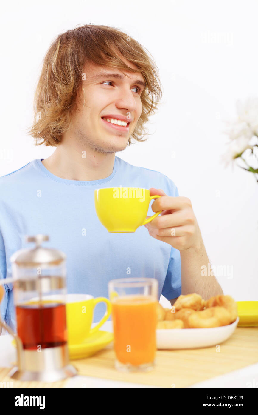 Young happy man drinking tea Stock Photo - Alamy