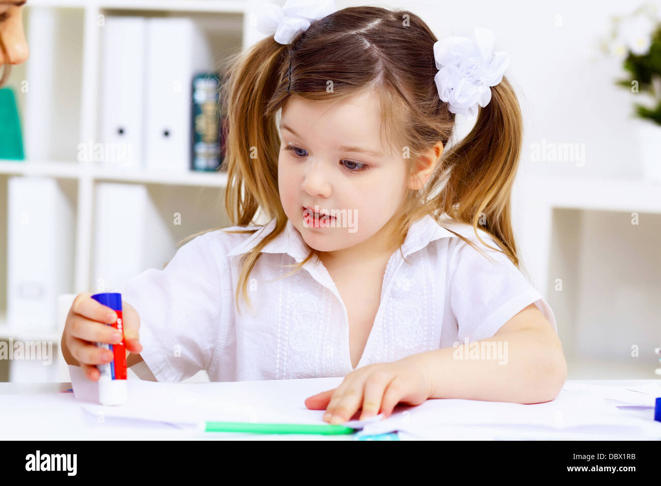 Little girl and her mother studying Stock Photo - Alamy