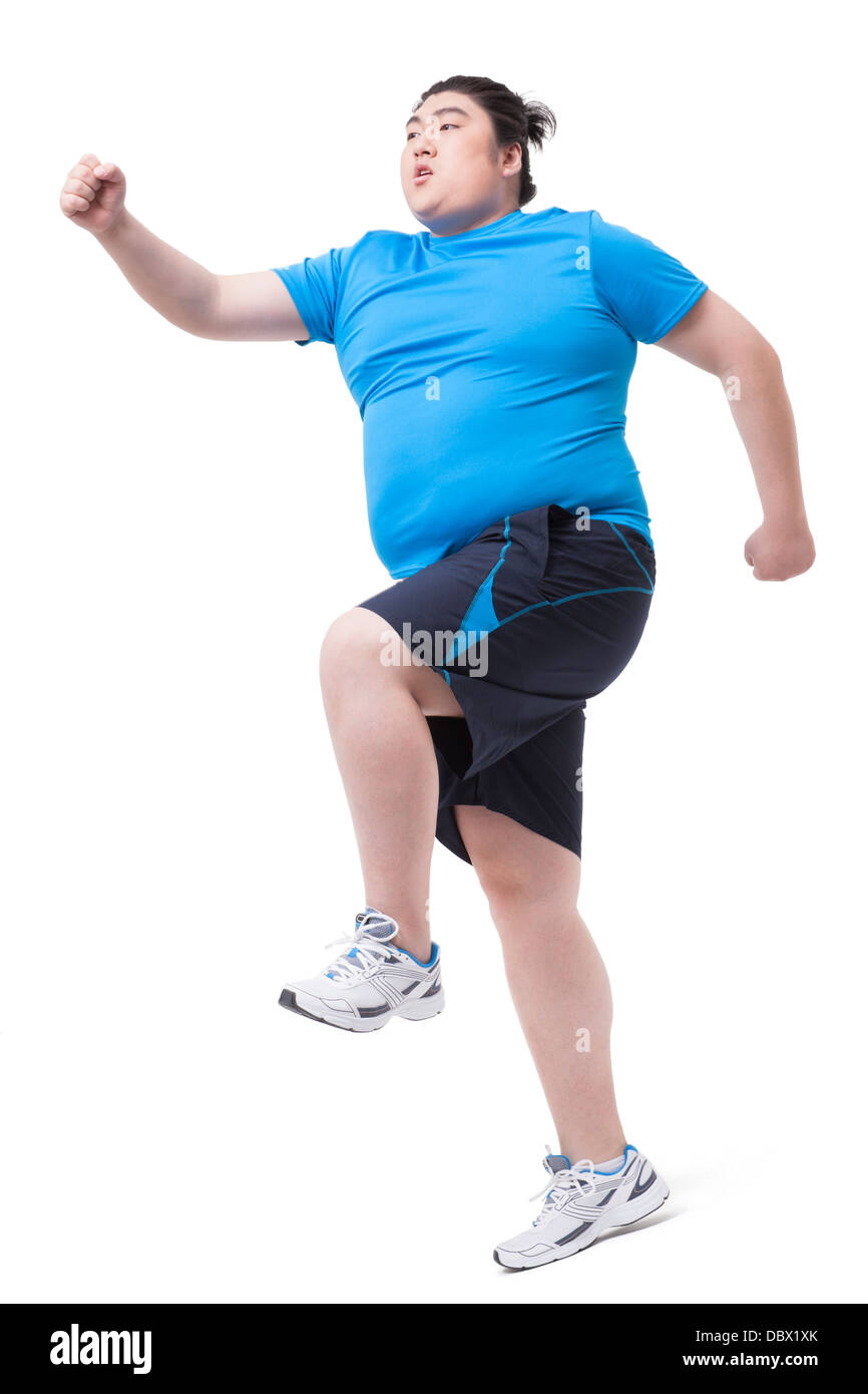 Overweight man running with difficulty Stock Photo - Alamy