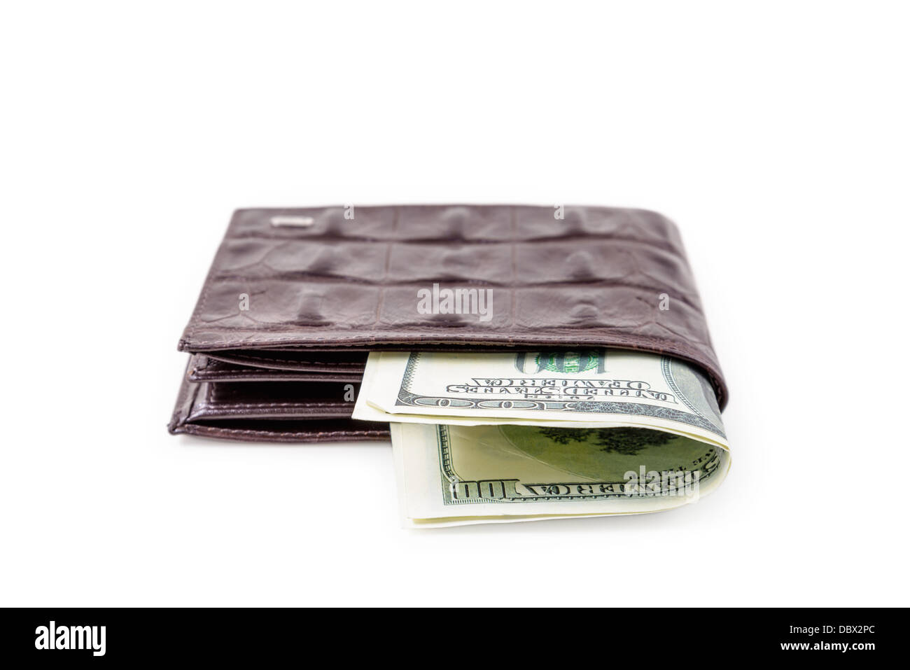 The brown leather wallet with dollars is photographed on the close-up ...