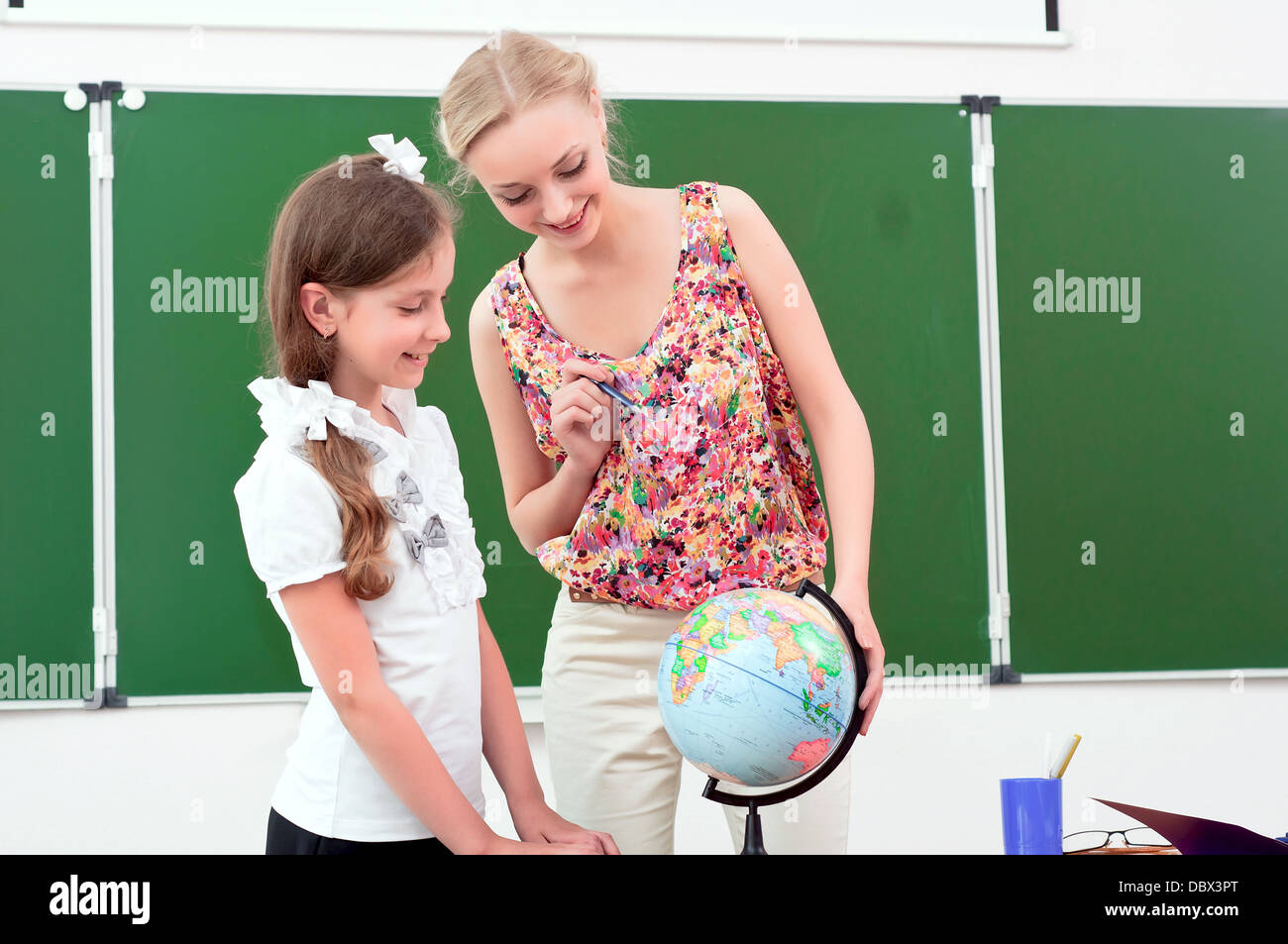 teacher explains the lesson in geography Stock Photo - Alamy