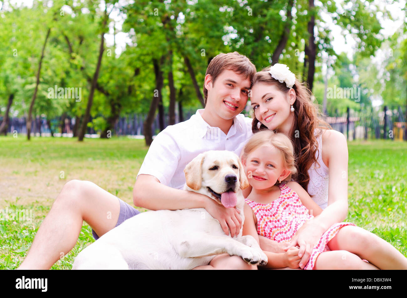 Happy young family with Labrador Stock Photo - Alamy