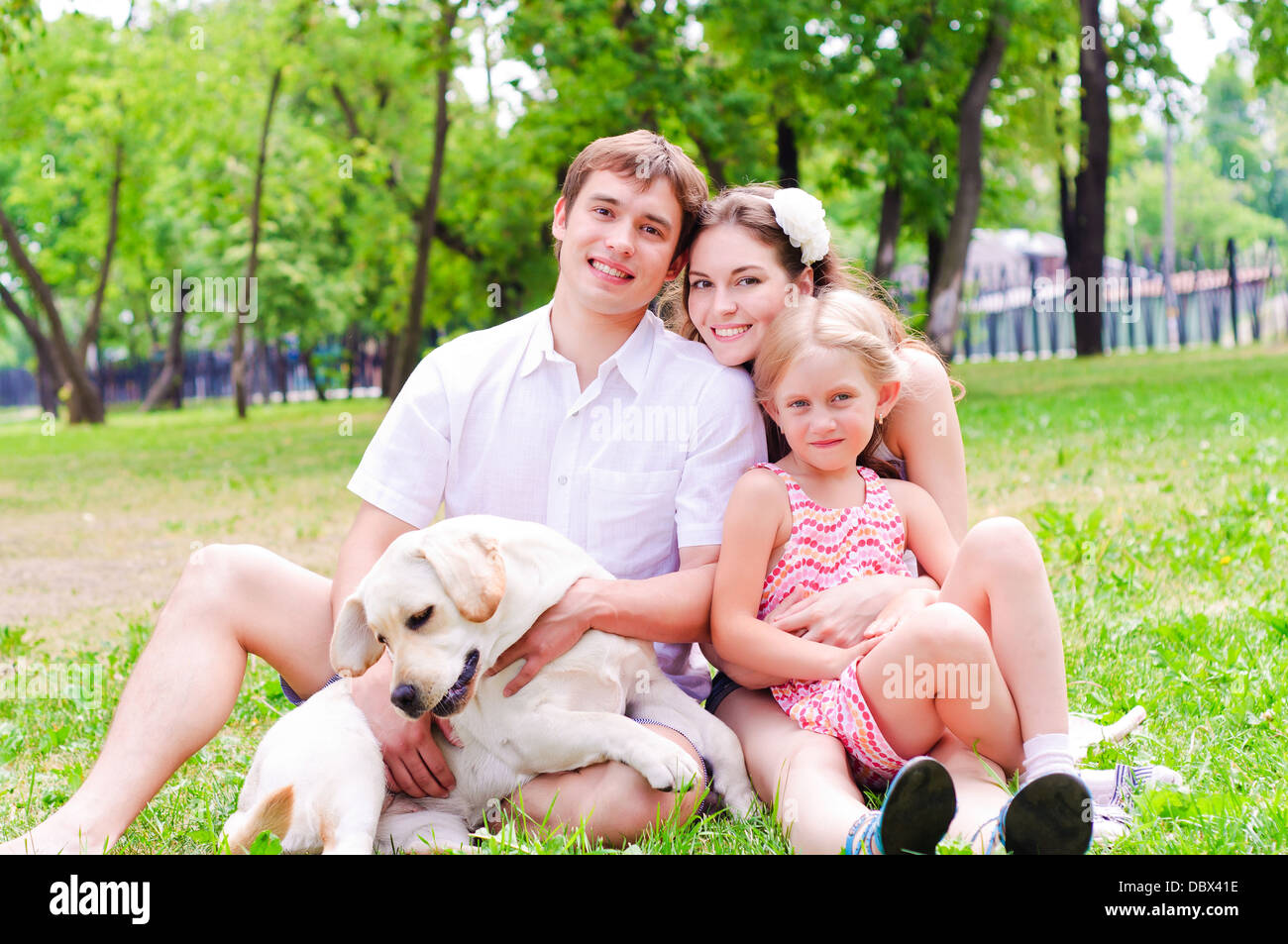 Happy young family with Labrador Stock Photo - Alamy