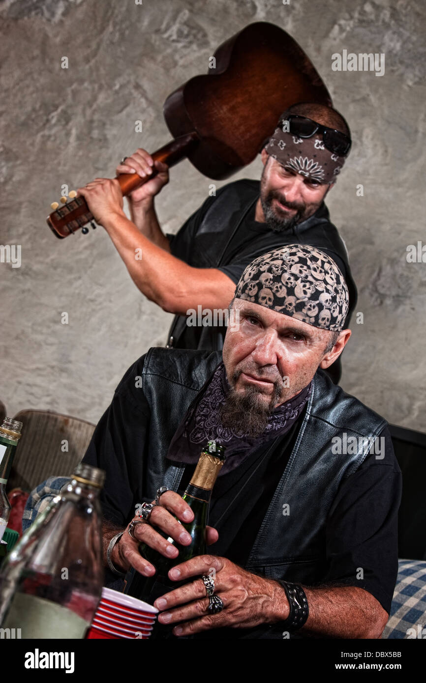 Man Hitting Someone with a Guitar Stock Photo - Alamy
