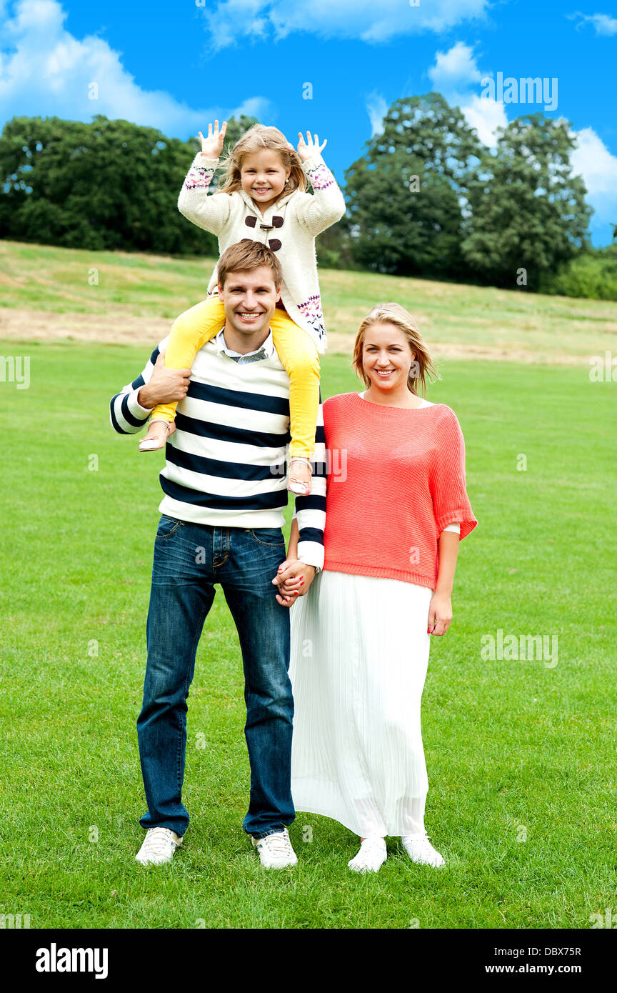 Family of three posing against natural background Stock Photo - Alamy
