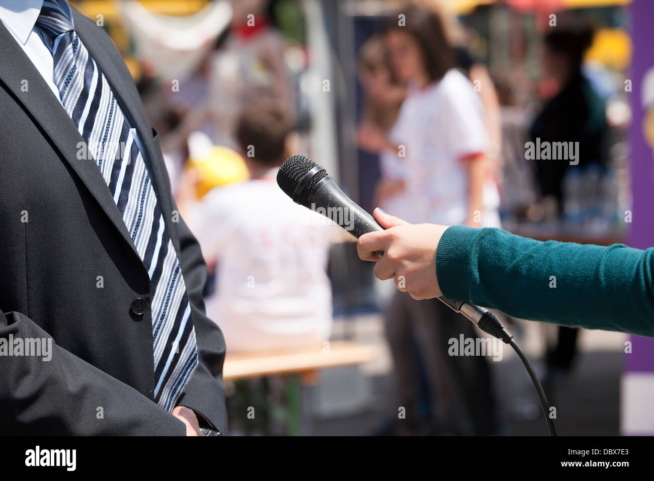 A journalist is making a interview with a microphone Stock Photo - Alamy