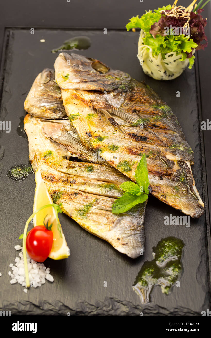 sea fish cooked on the grill Stock Photo - Alamy