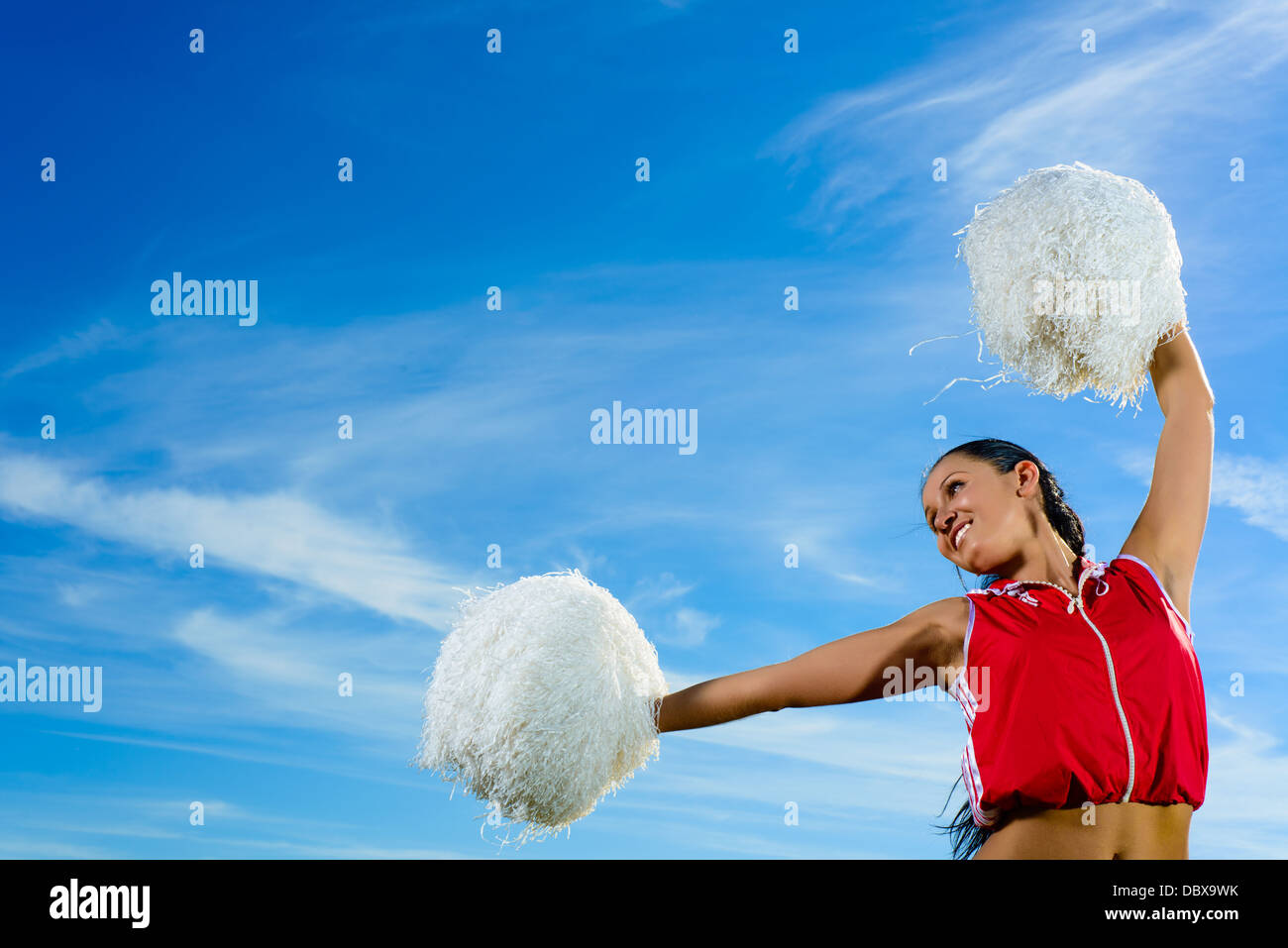Young cheerleader in red costume with pampon Stock Photo - Alamy