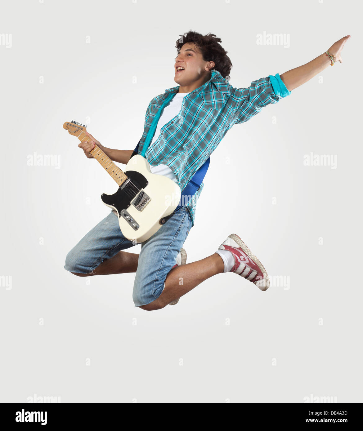 young man playing on electro guitar and jumping Stock Photo - Alamy