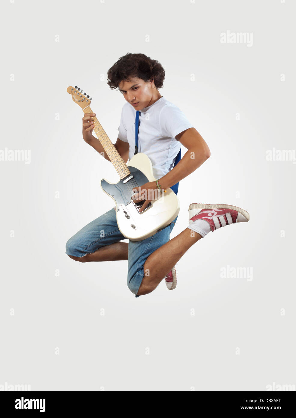 young man playing on electro guitar and jumping Stock Photo - Alamy