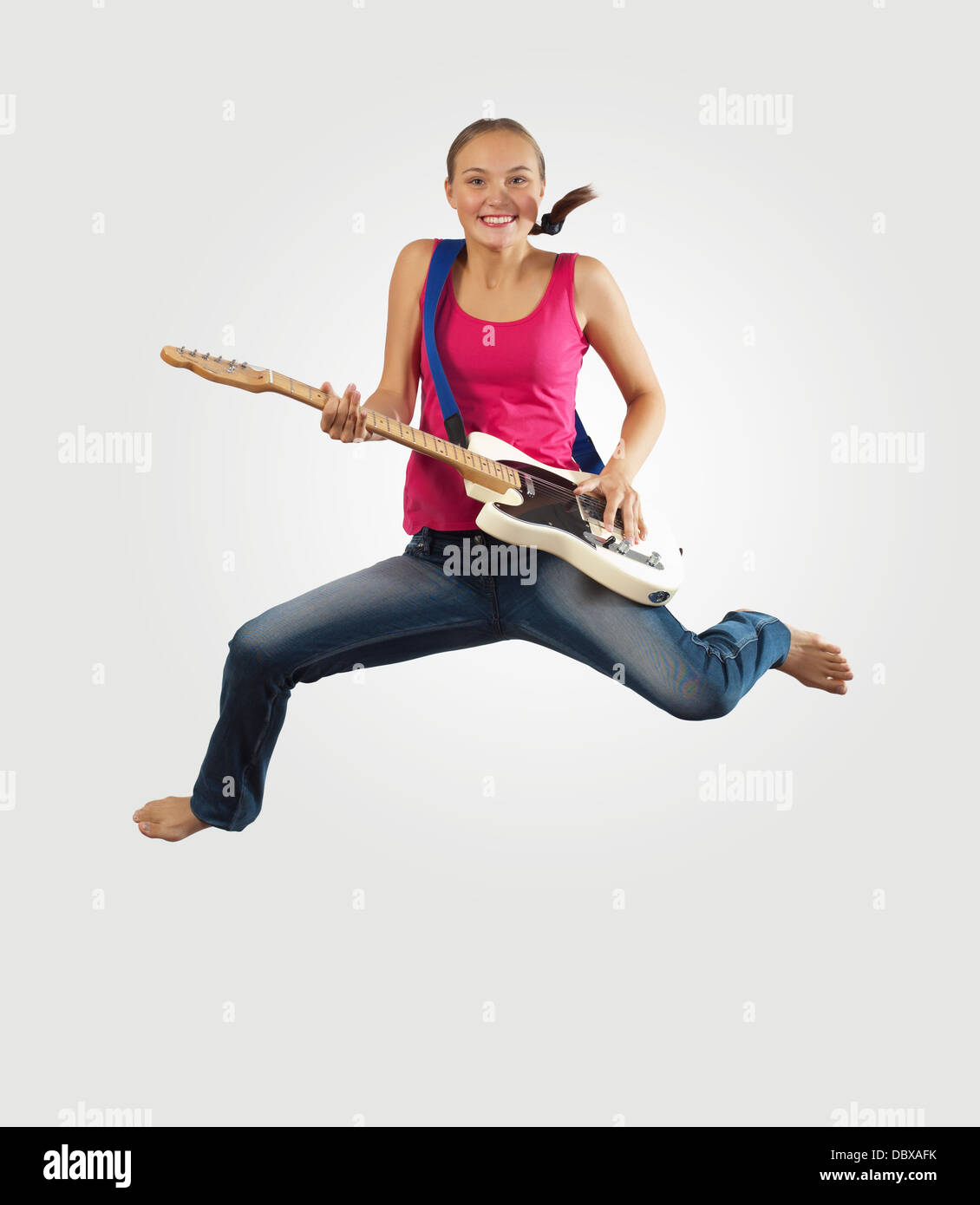 young woman playing on electro guitar and jumping Stock Photo - Alamy