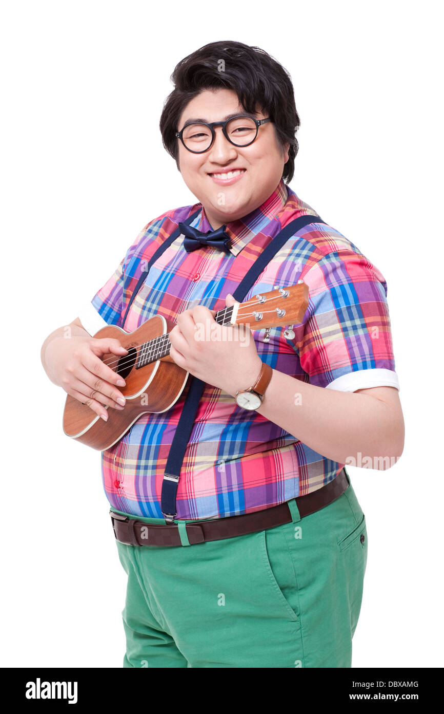 Happy overweight man playing small guitar Stock Photo - Alamy