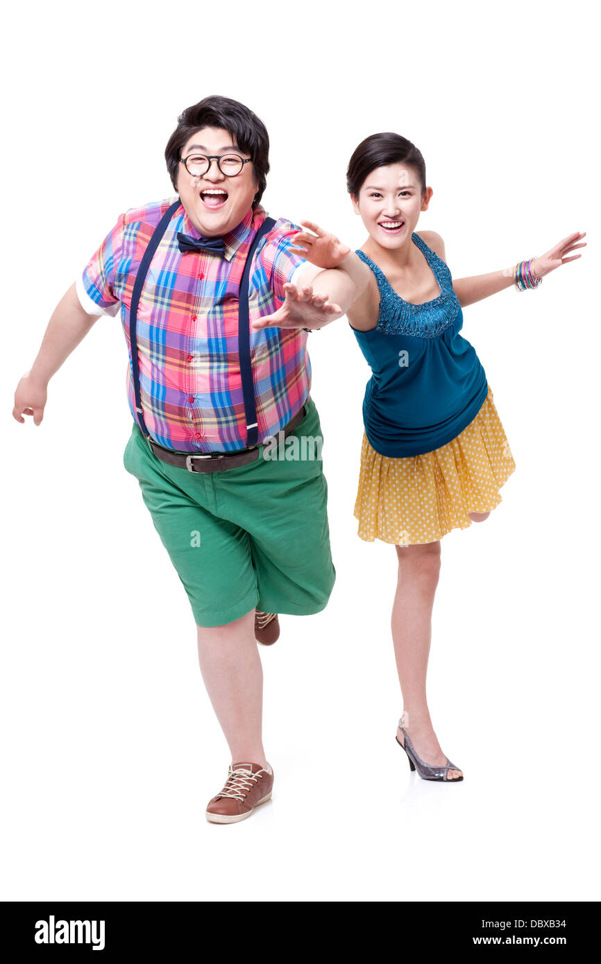 Funny fat man and girlfriend running forward Stock Photo - Alamy