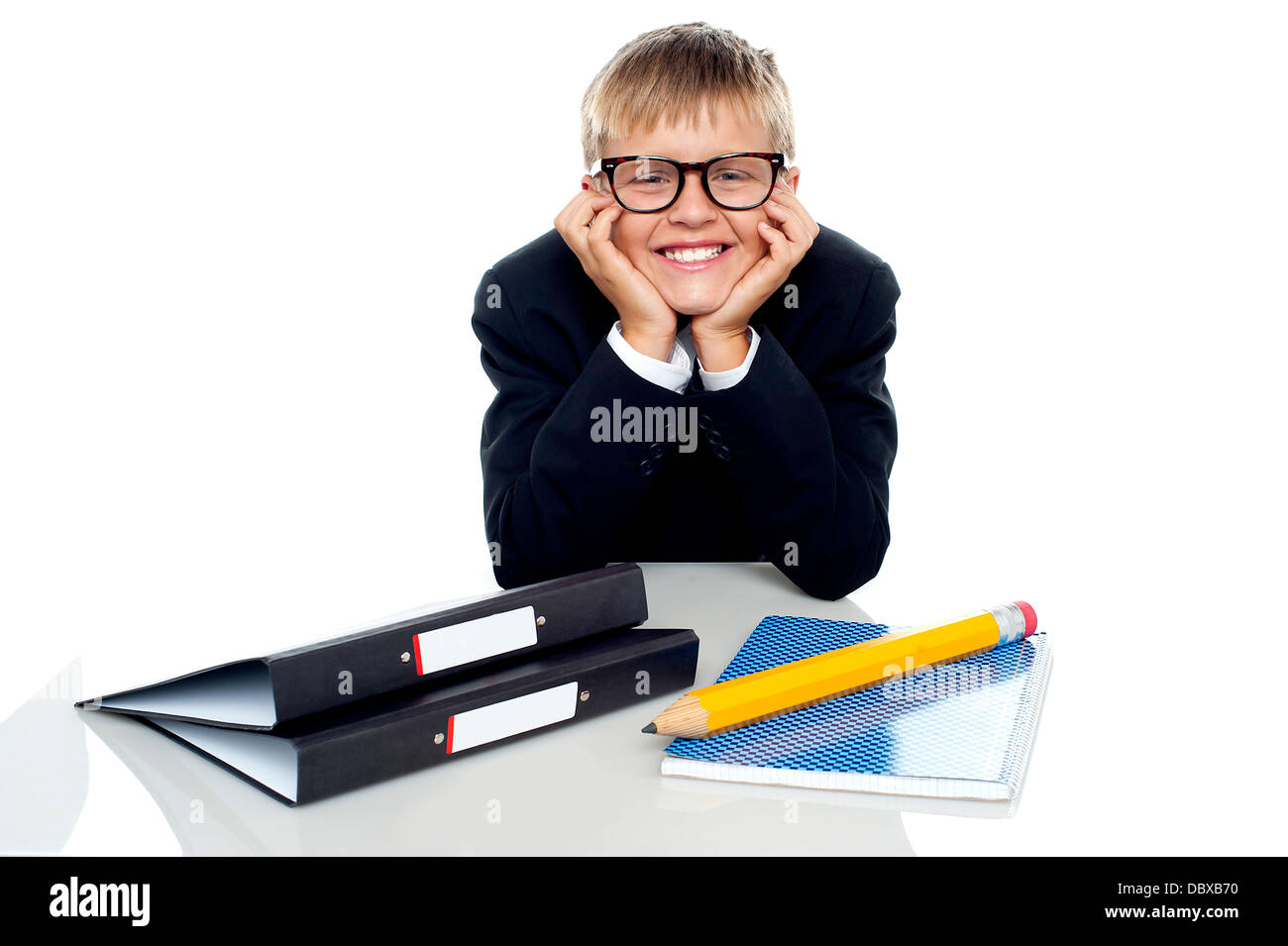 Bespectacled boy posing with files on his desk Stock Photo - Alamy
