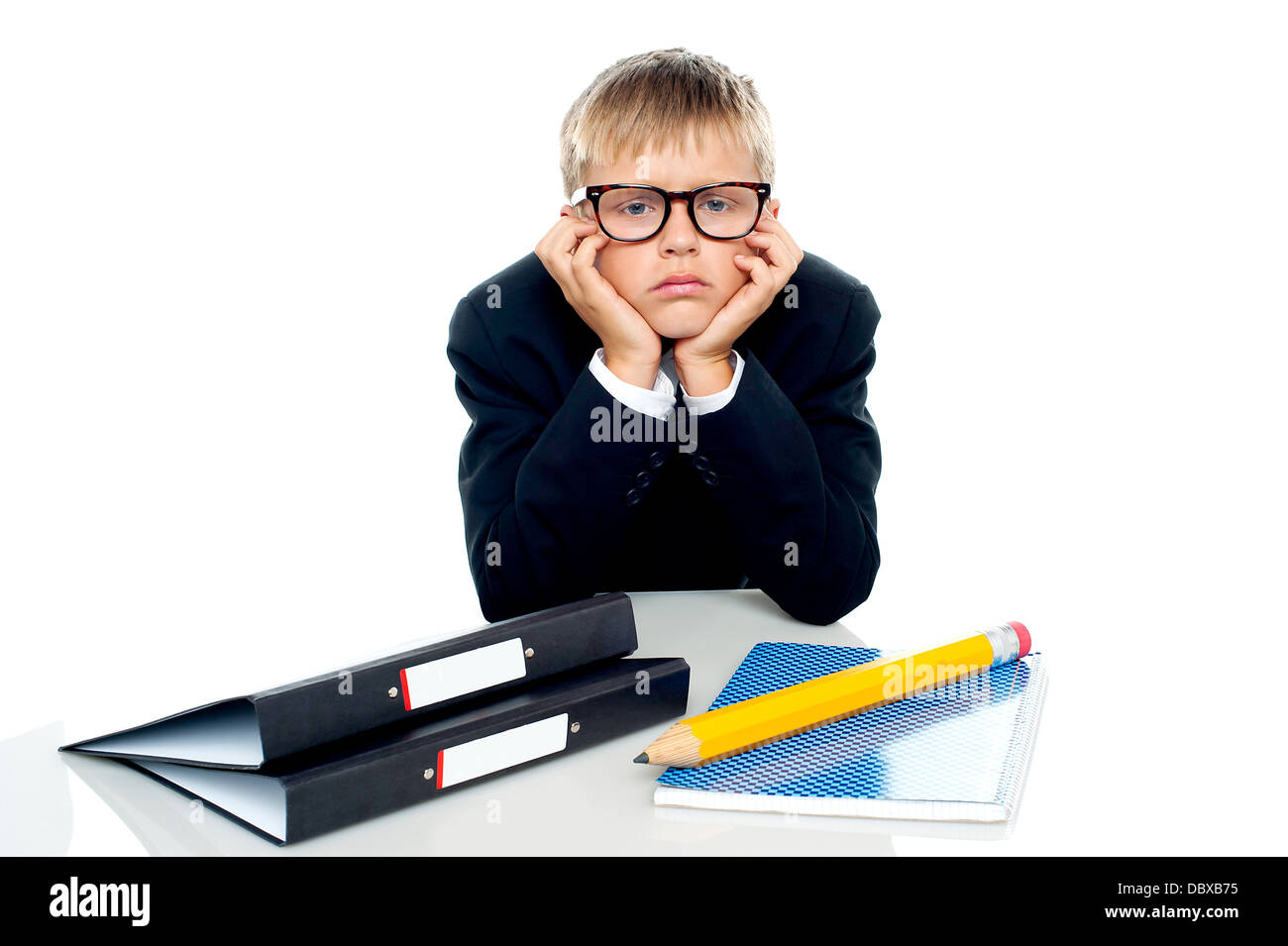 Sad looking boy with hands on his cheeks Stock Photo - Alamy