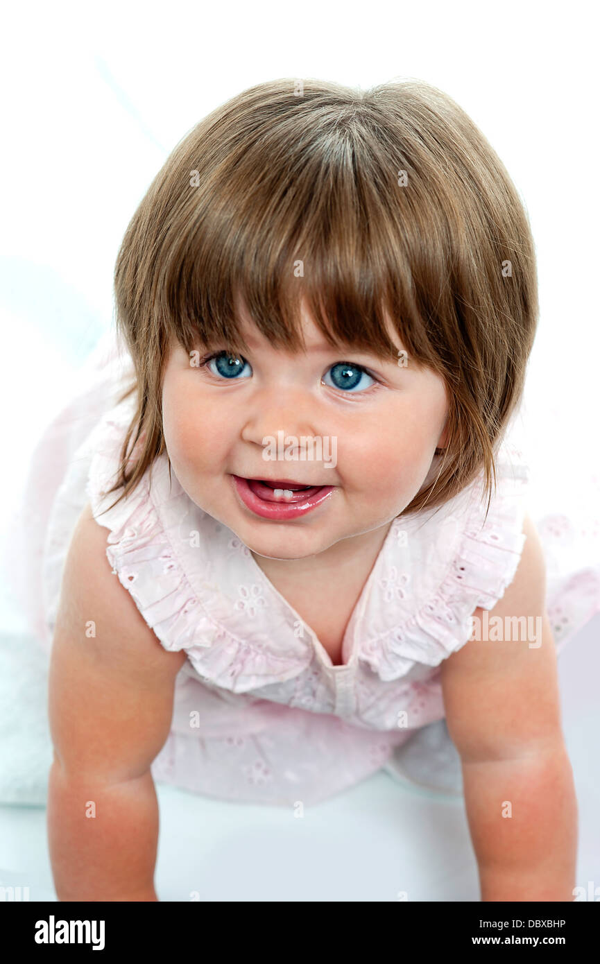 Baby girl with milk teeth crawling on the ground Stock Photo - Alamy