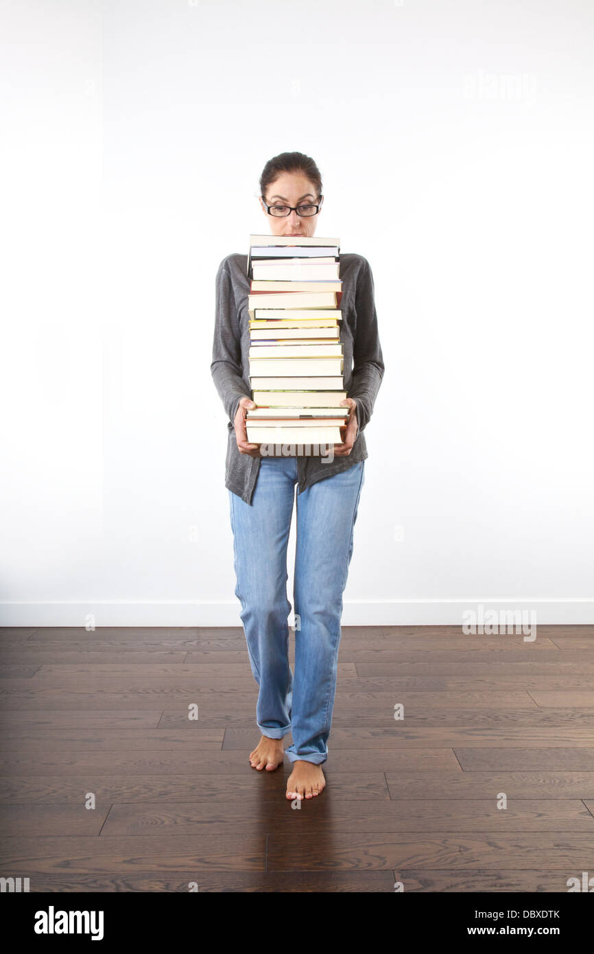 woman with a pile of books Stock Photo - Alamy