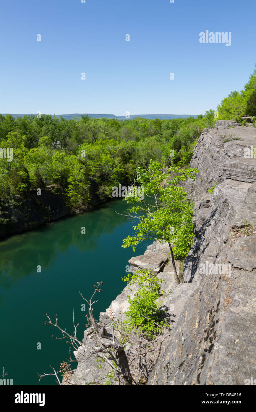 Rock cliffs overlooking a pond at a former quarry Stock Photo - Alamy