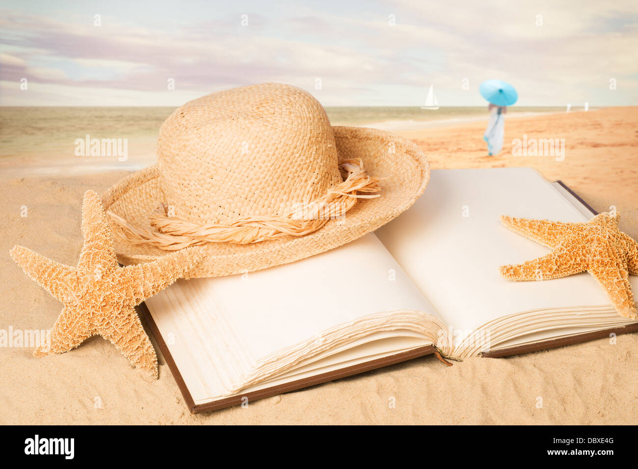 Straw hat on open book with vintage feel Stock Photo - Alamy