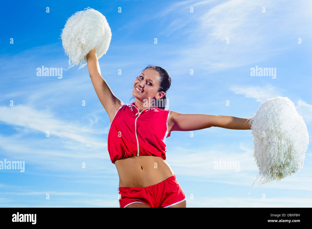 Young cheerleader in red costume with pampon Stock Photo - Alamy