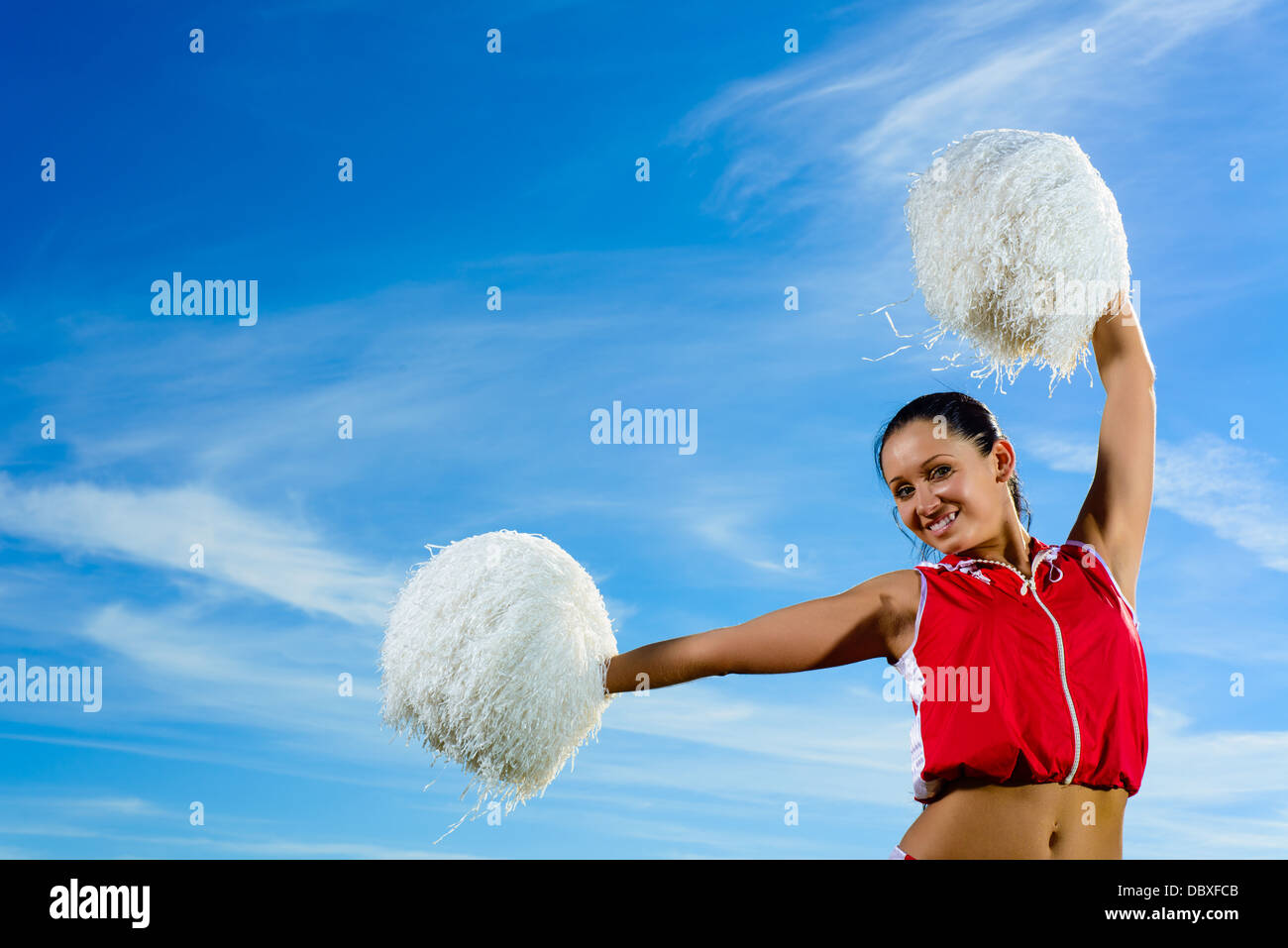 Young cheerleader in red costume with pampon Stock Photo - Alamy