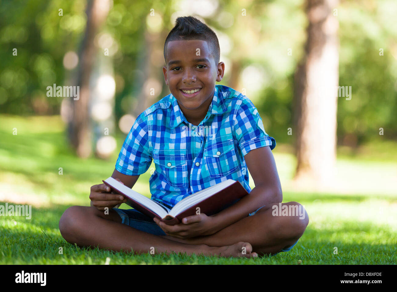Little black boy outdoor reading hi-res stock photography and images ...