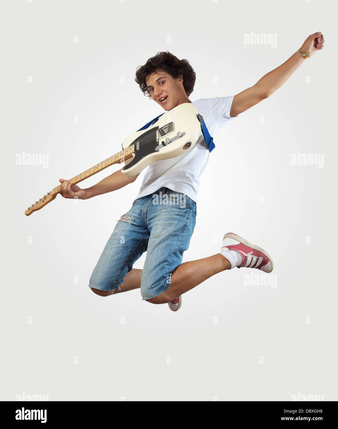 young man playing on electro guitar and jumping Stock Photo - Alamy