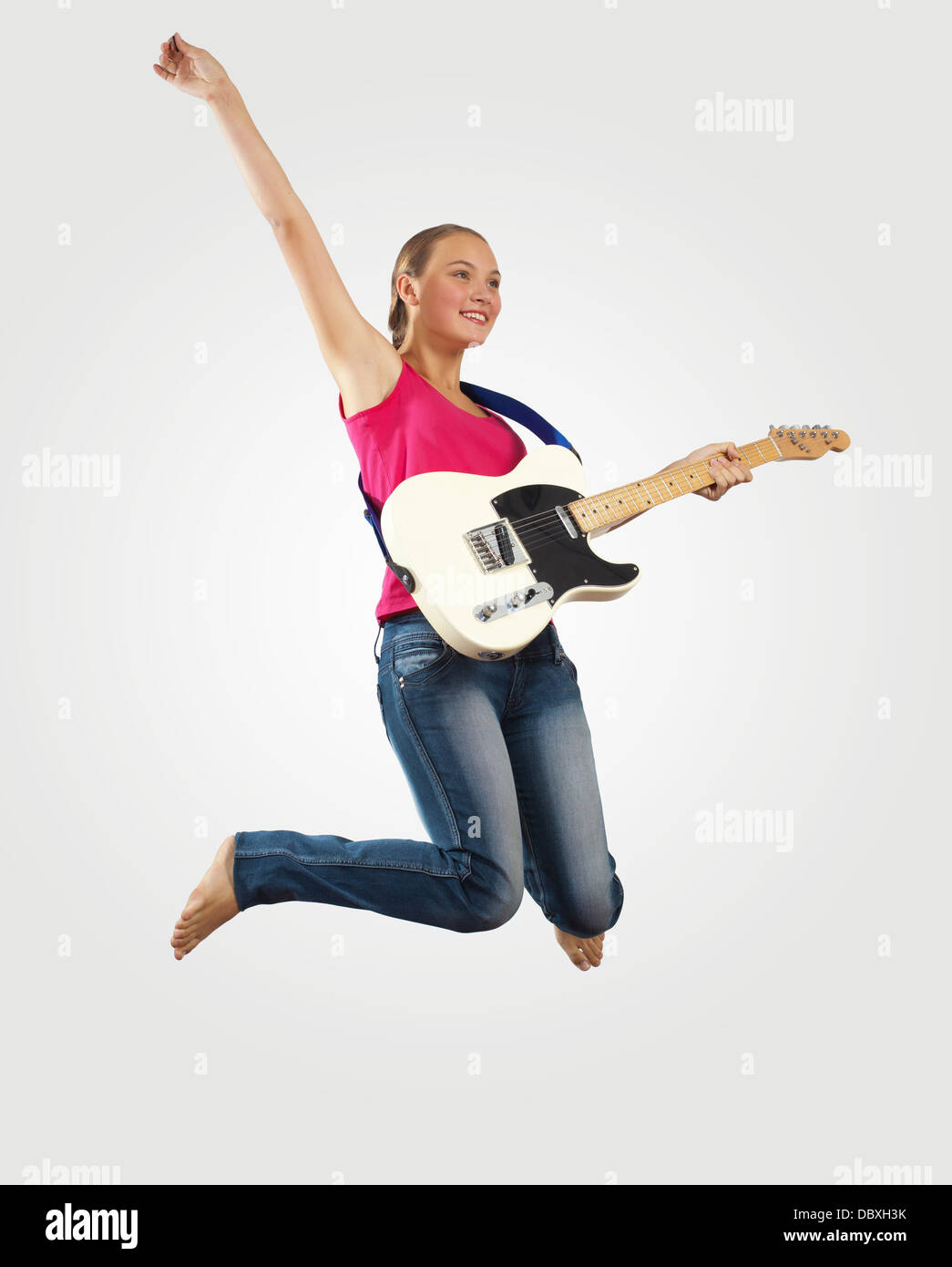 young woman playing on electro guitar and jumping Stock Photo - Alamy
