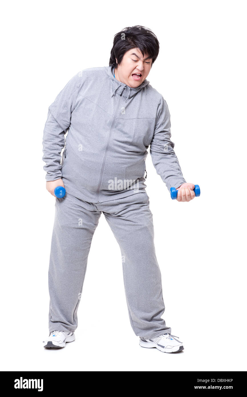 Overweight man taking exercise by lifting dumbbell Stock Photo - Alamy
