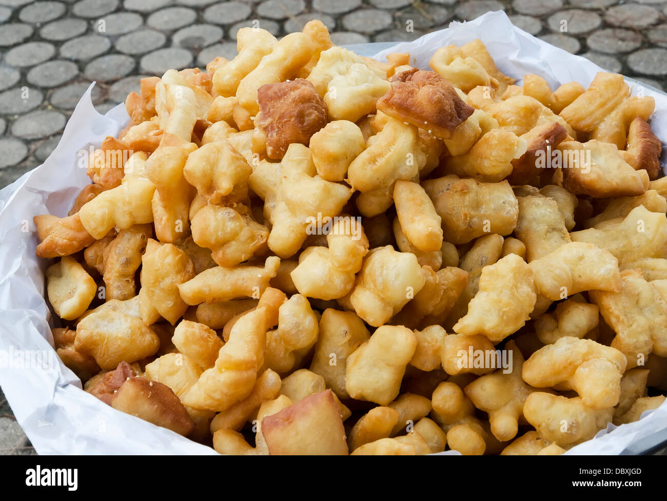 Deep-fried dough stick on paper Stock Photo - Alamy