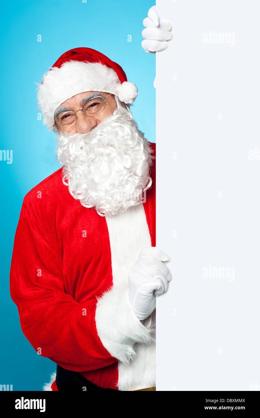 Santa posing beside long blank banner ad Stock Photo - Alamy