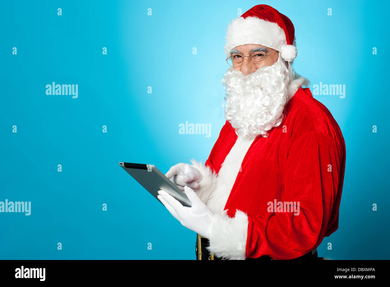 Santa using newly launched electronic tablet device Stock Photo - Alamy