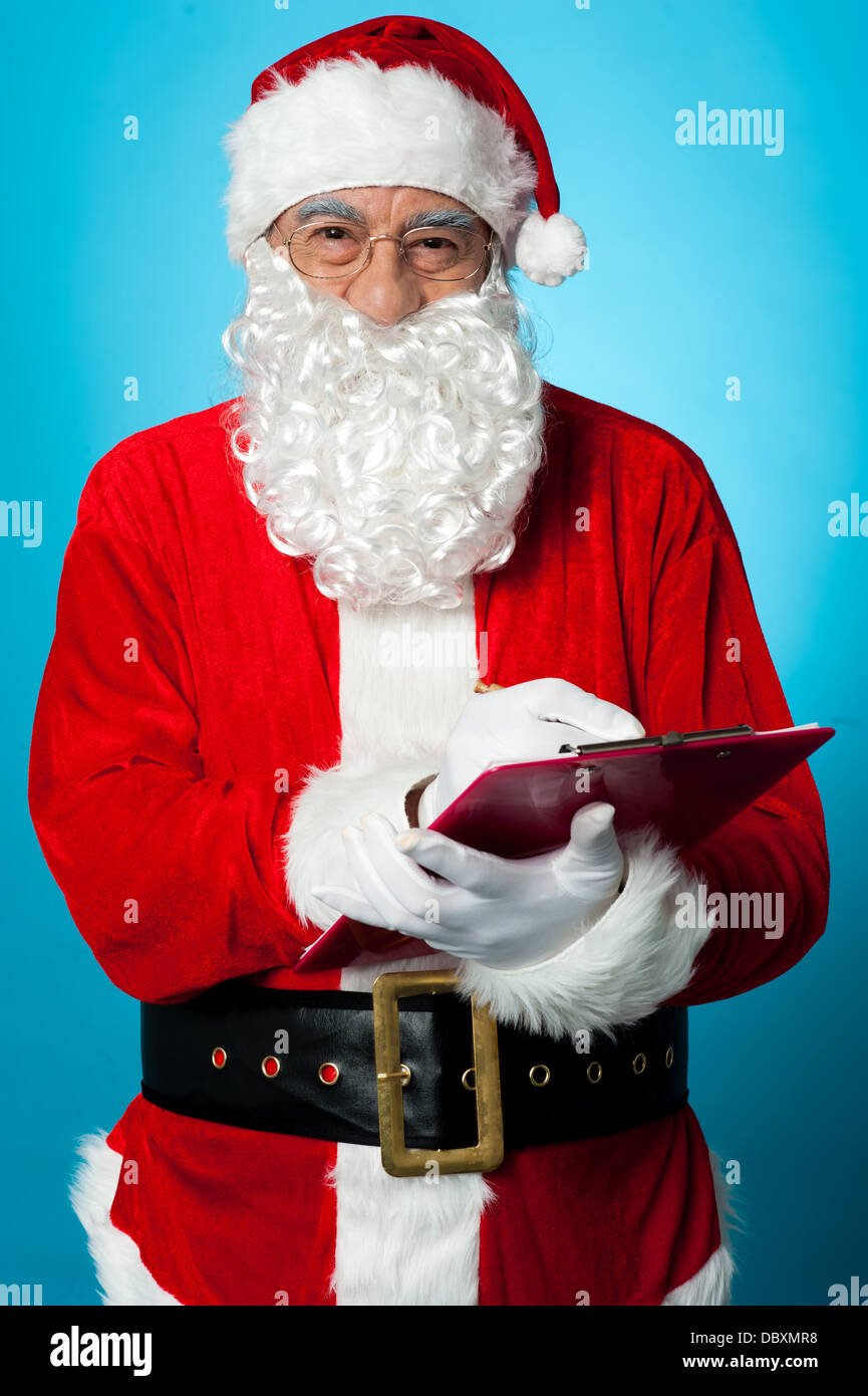 Father Nicholas preparing a list of gift recipients Stock Photo - Alamy