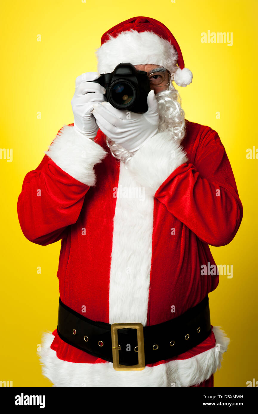 Smile please! Santa capturing a perfect frame Stock Photo - Alamy