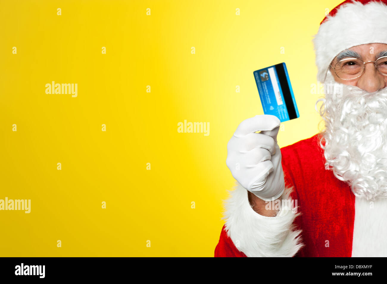 Cropped image of aged Santa holding credit card Stock Photo - Alamy