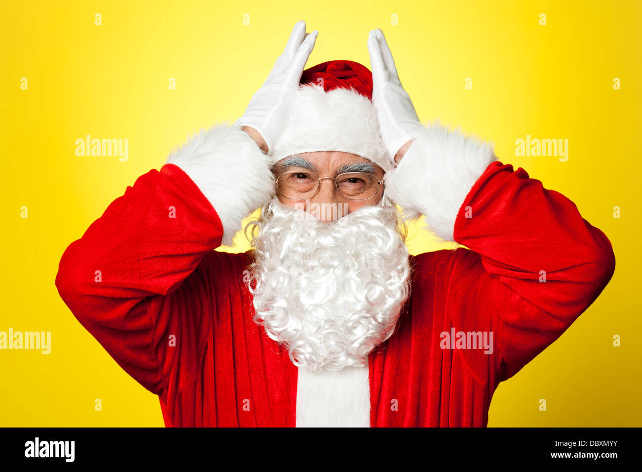Stressed out Santa pressing against his temples Stock Photo - Alamy