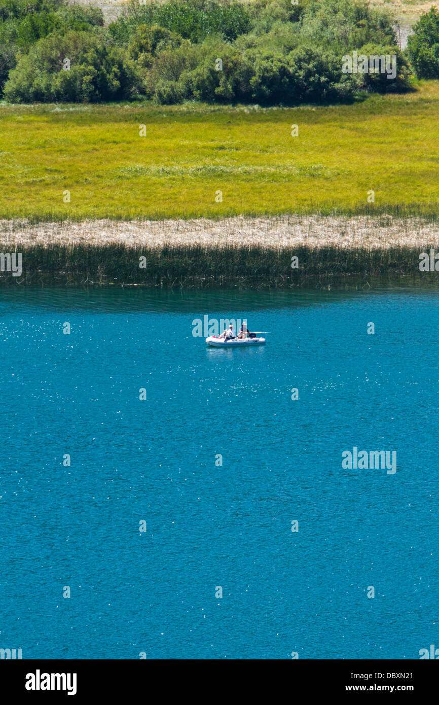 Fisherman on the Turquoise waters of June Lake in June Lake California ...