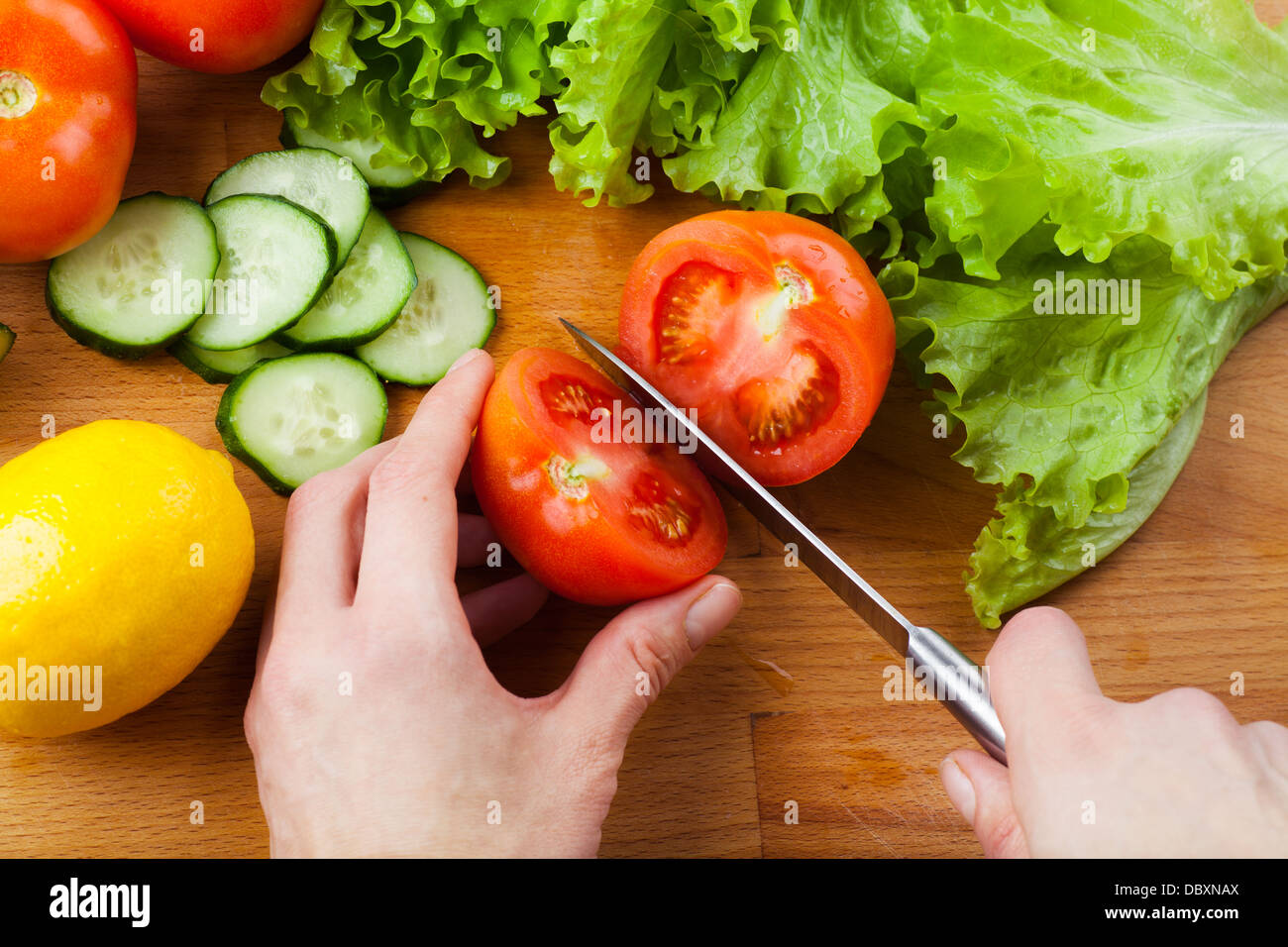 Hand holding knife cutting lemon hi-res stock photography and images ...