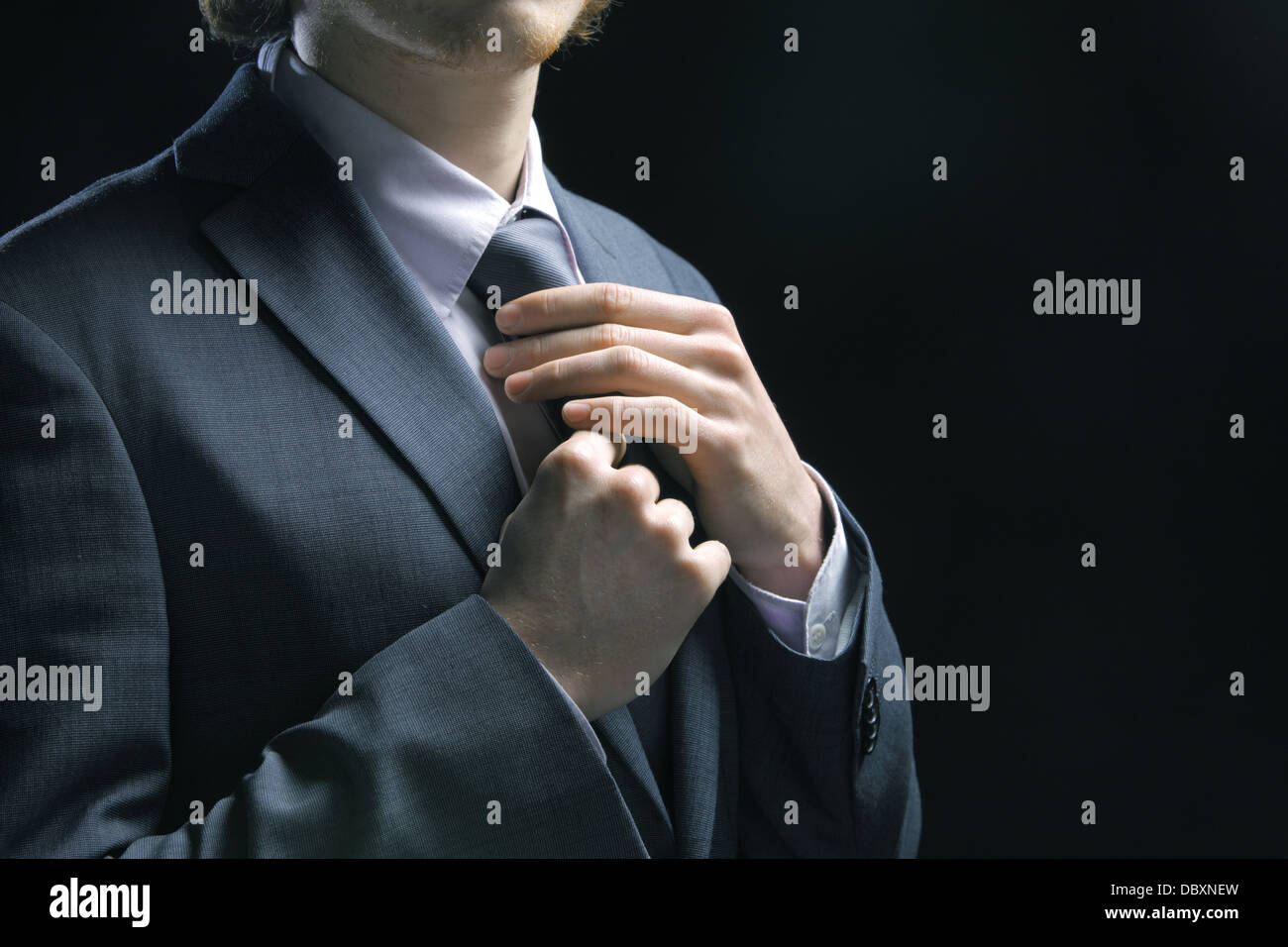 Adjusting mans tie hi-res stock photography and images - Alamy