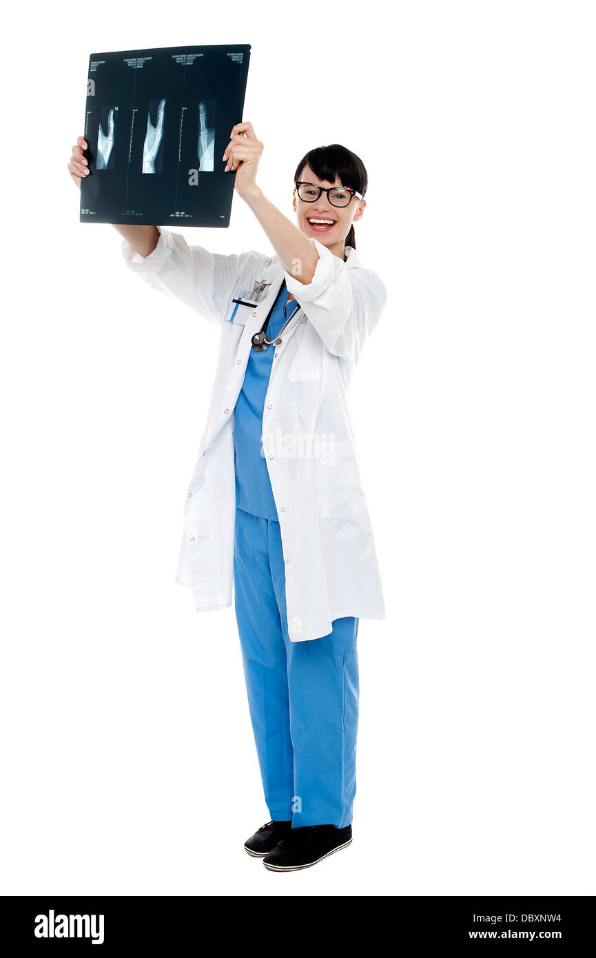 Nurse holding x-ray sheet against light to examine Stock Photo - Alamy