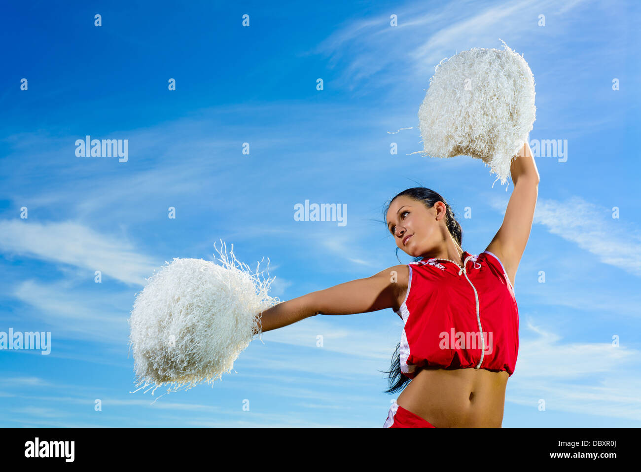 Young cheerleader in red costume with pampon Stock Photo - Alamy