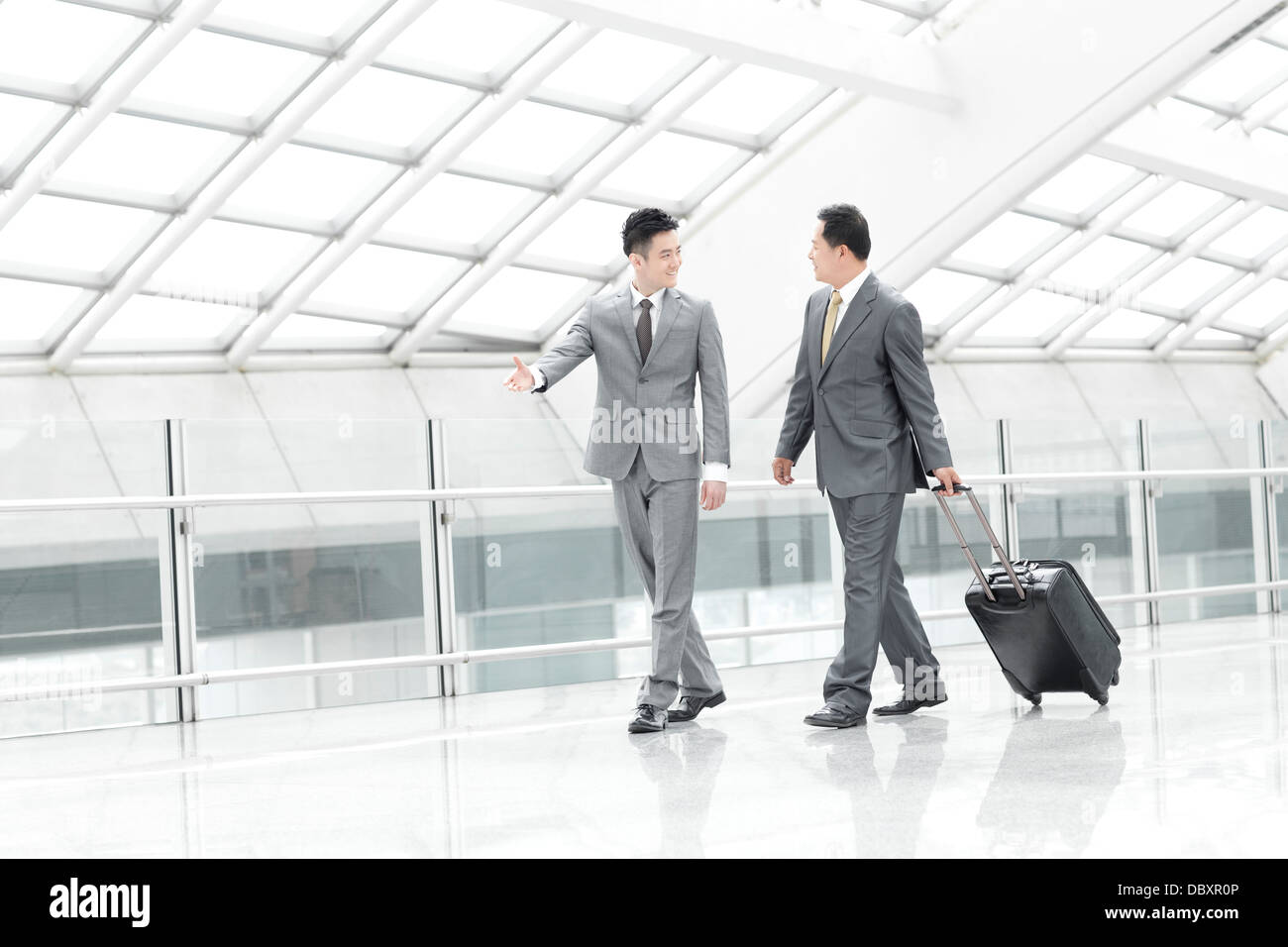 Business partners on the move in airport lobby Stock Photo - Alamy
