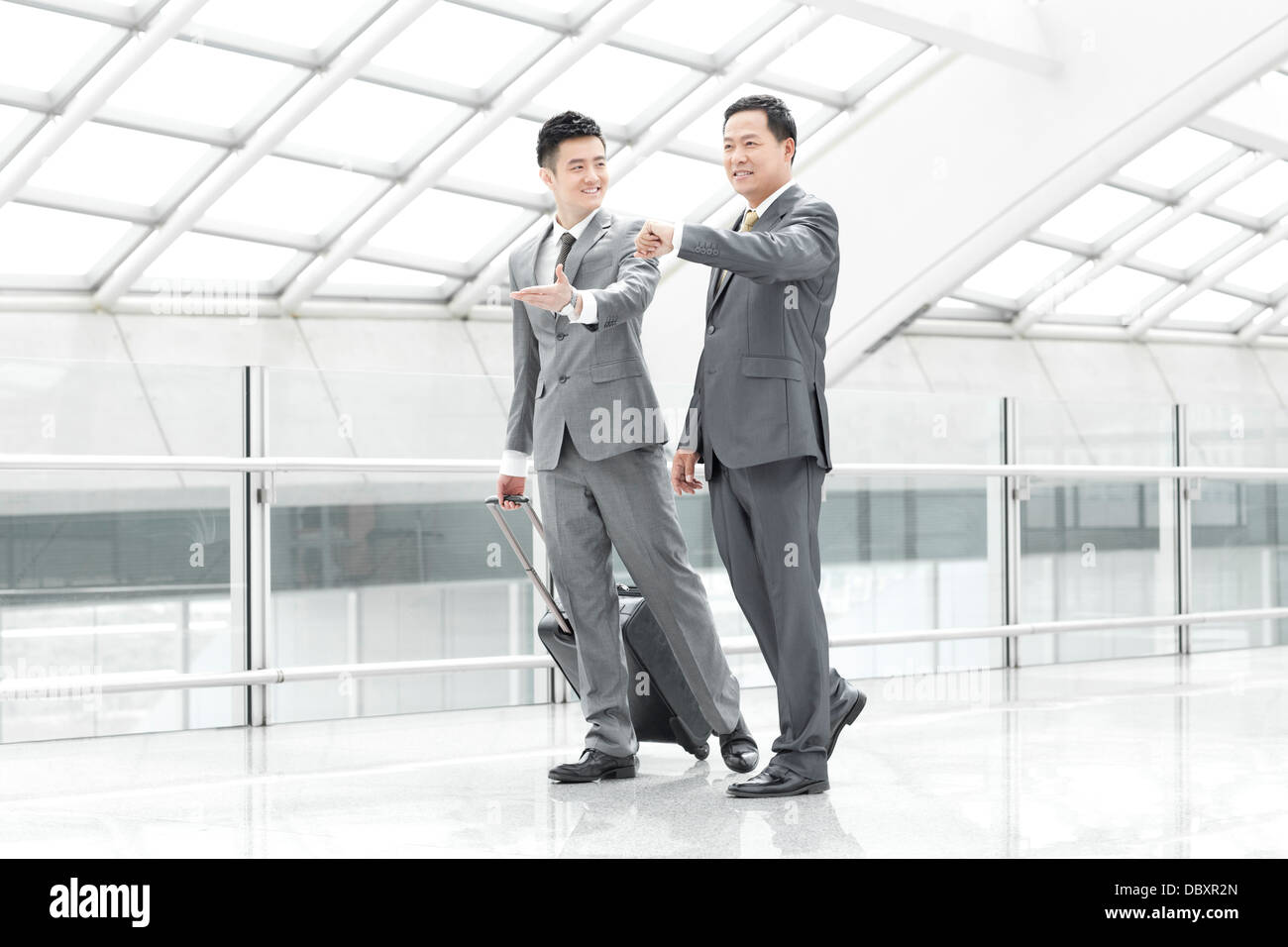 Business partners on the move in airport lobby Stock Photo - Alamy