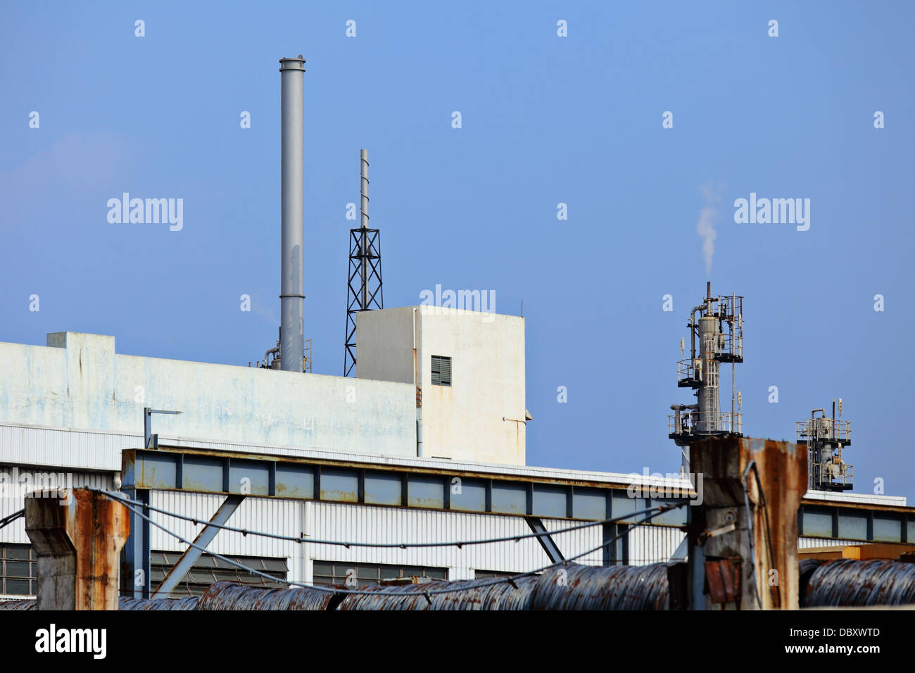 Industrial landscape with factory chimney Stock Photo - Alamy