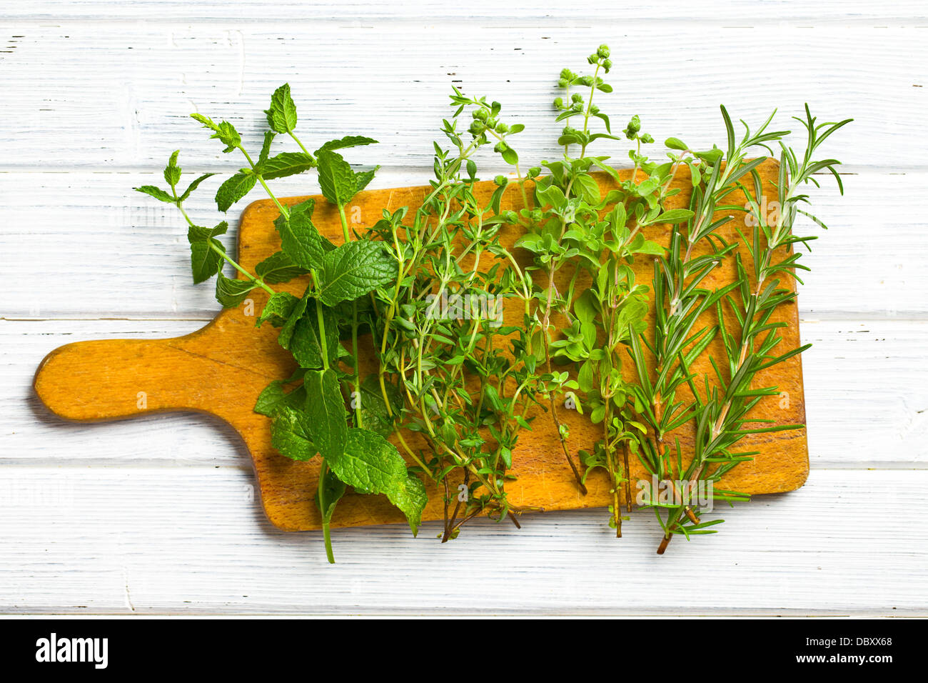 various herbs on kitchen table Stock Photo - Alamy