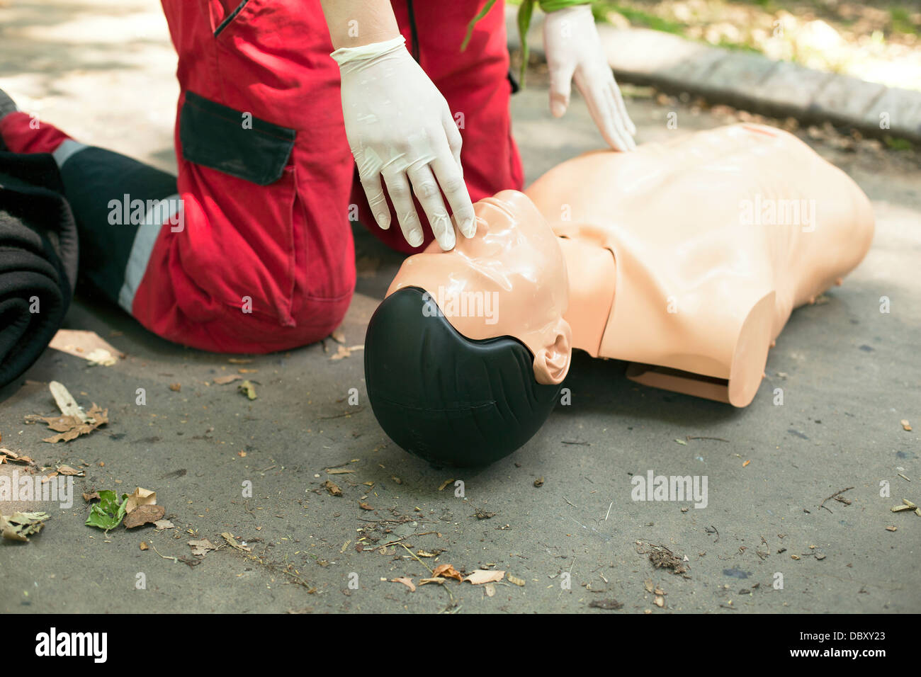 CPR practitioner examining airways on dummy Stock Photo - Alamy