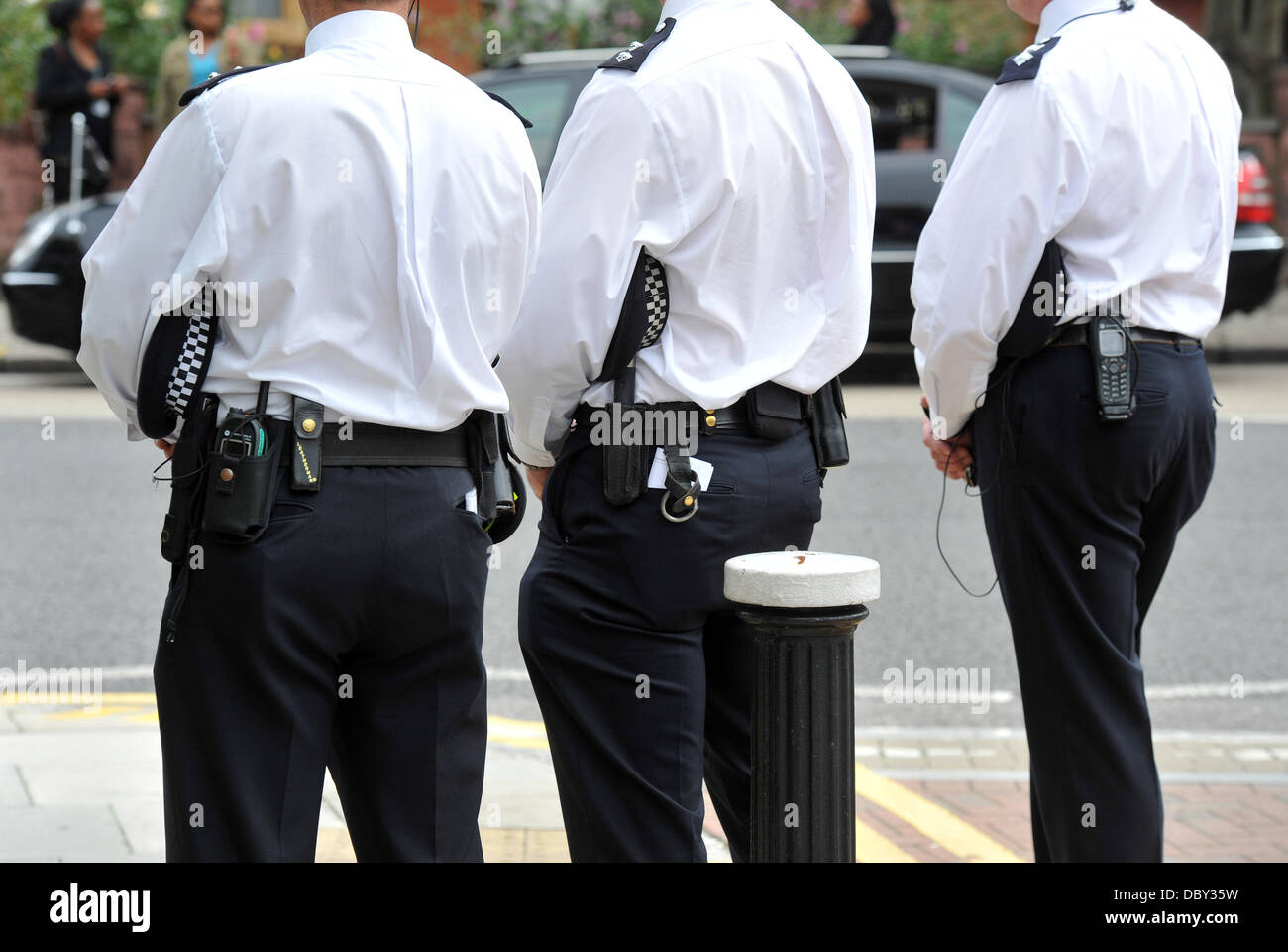 Police officers take their hats off in respect as the funeral cortege ...