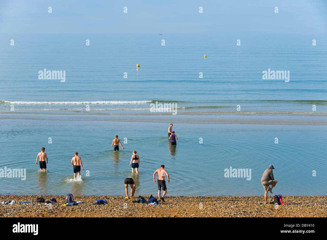 Early morning group of bathers on the beach in Brighton East Sussex ...