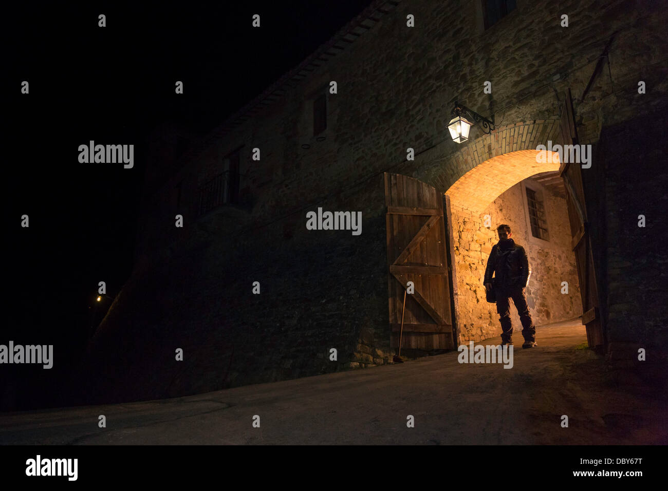 Man standing outside the gate of the medieval city Stock Photo - Alamy