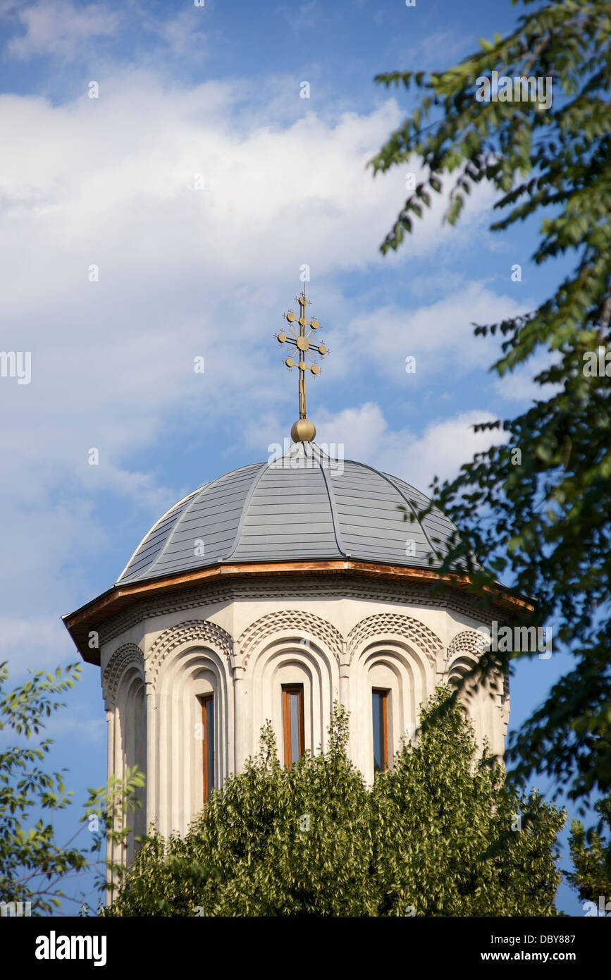 Round church spire with crucifix on top in Bucharest Stock Photo - Alamy